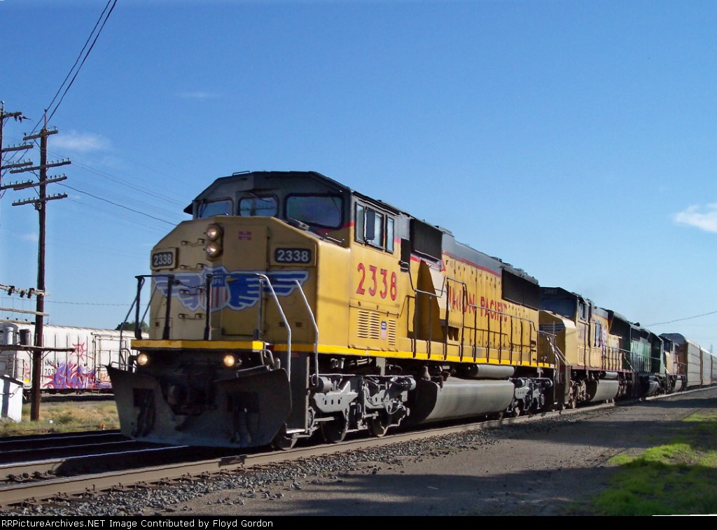 UP 2338 (SD60M) speeds west with auto racks